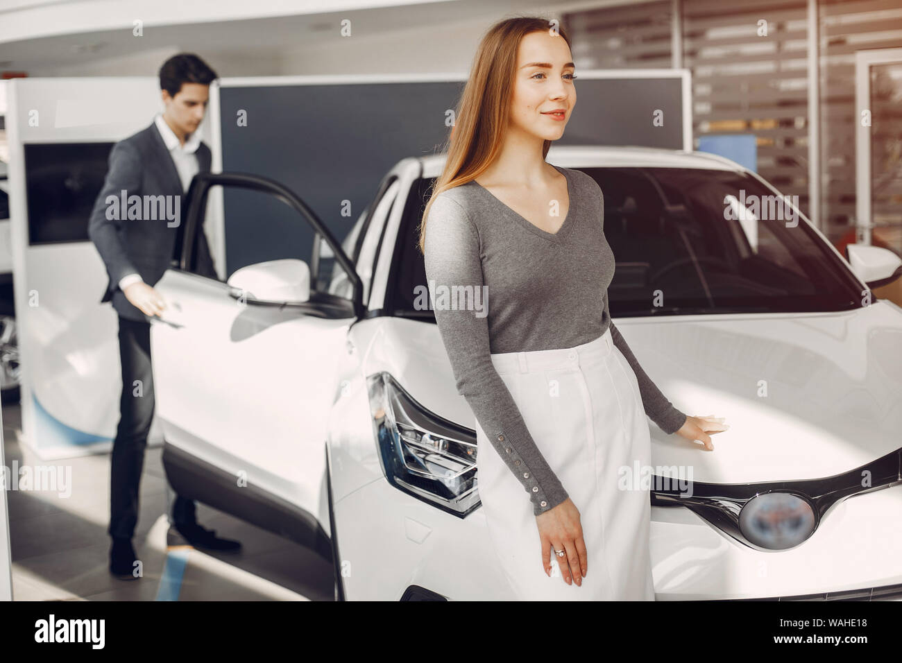 Elegant couple in a car salon Stock Photo - Alamy