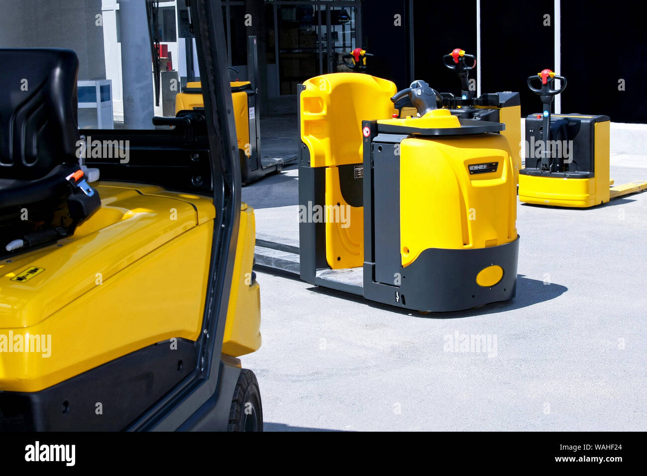 Yellow cargo pallet transporters and fork lifters Stock Photo - Alamy