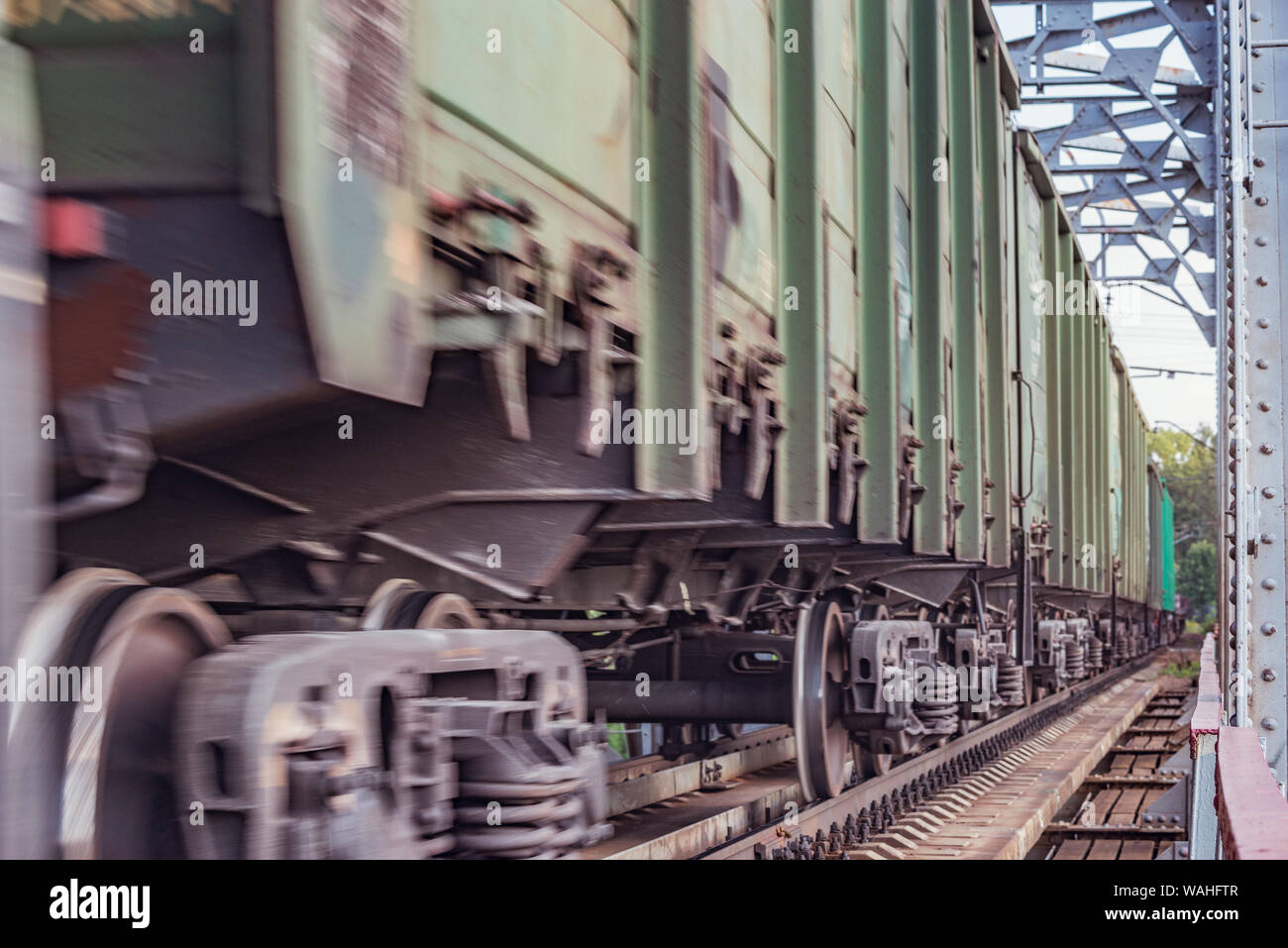 Freight train moves fastthrough the railway bridge Stock Photo - Alamy