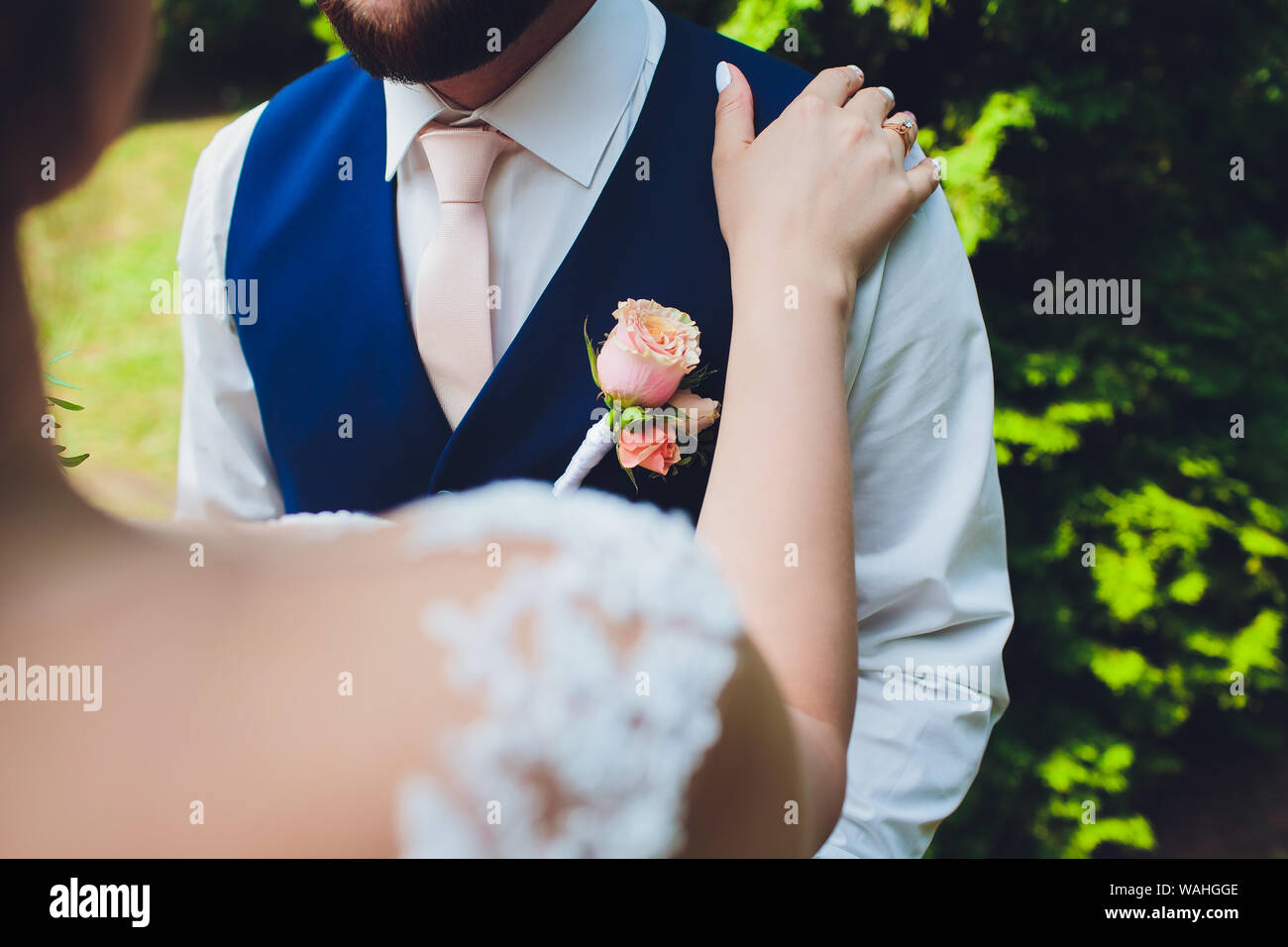 Beautiful wedding bouquet in the hands of the bride with roses. Wedding ...