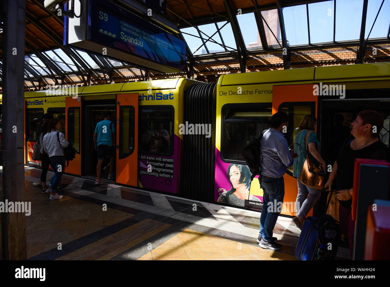 People board a U2 line subway network at the City Centre in Berlin ...