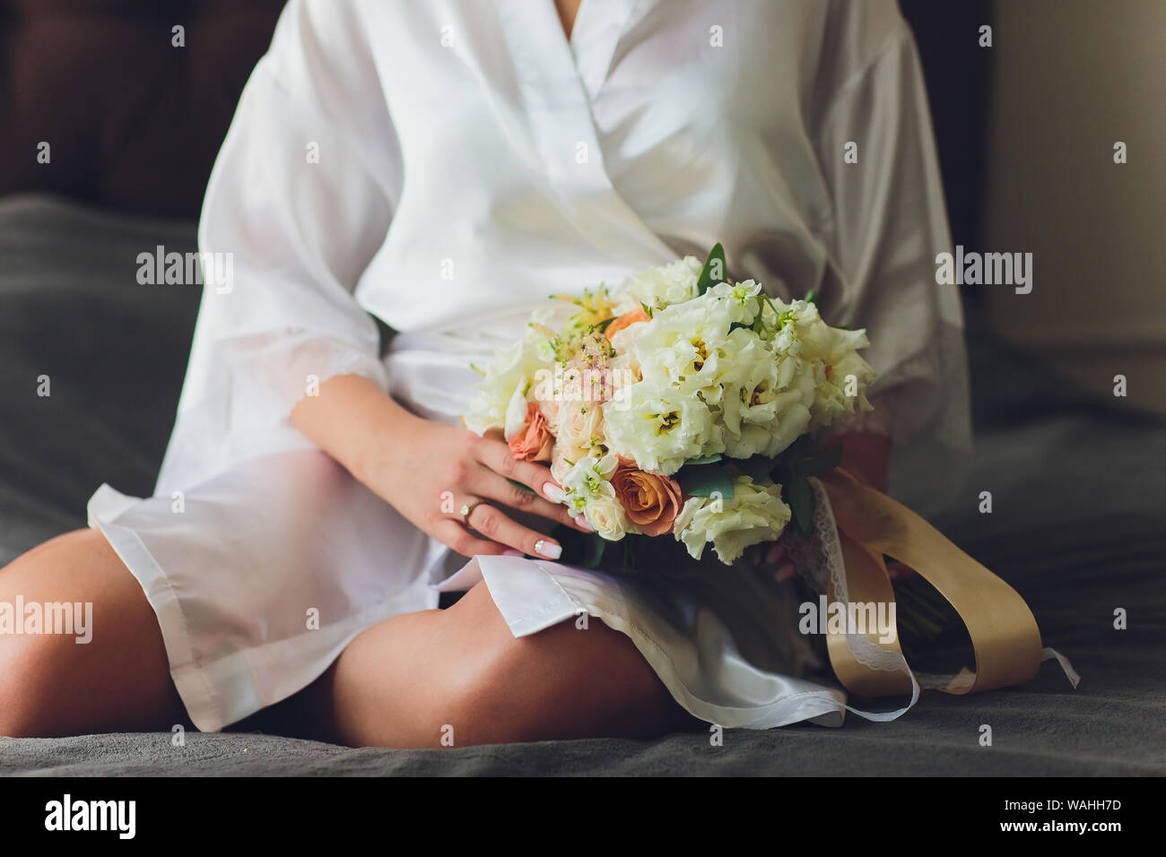 Beautiful wedding bouquet in the hands of the bride with roses. Wedding ...