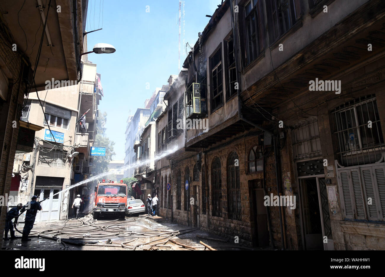 Damascus, Syria. 20th Aug, 2019. Firefighters spray water to extinguish ...