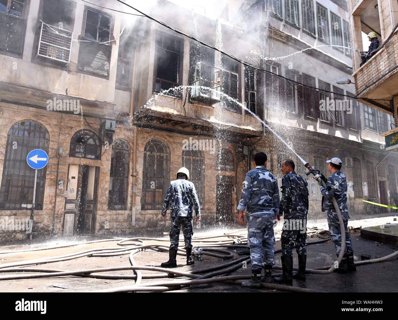 Damascus, Syria. 20th Aug, 2019. Firefighters spray water to extinguish ...