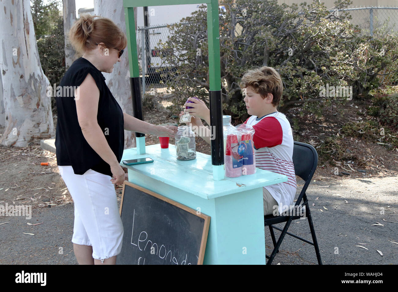 Young boy opens a lemonade stand Stock Photo - Alamy