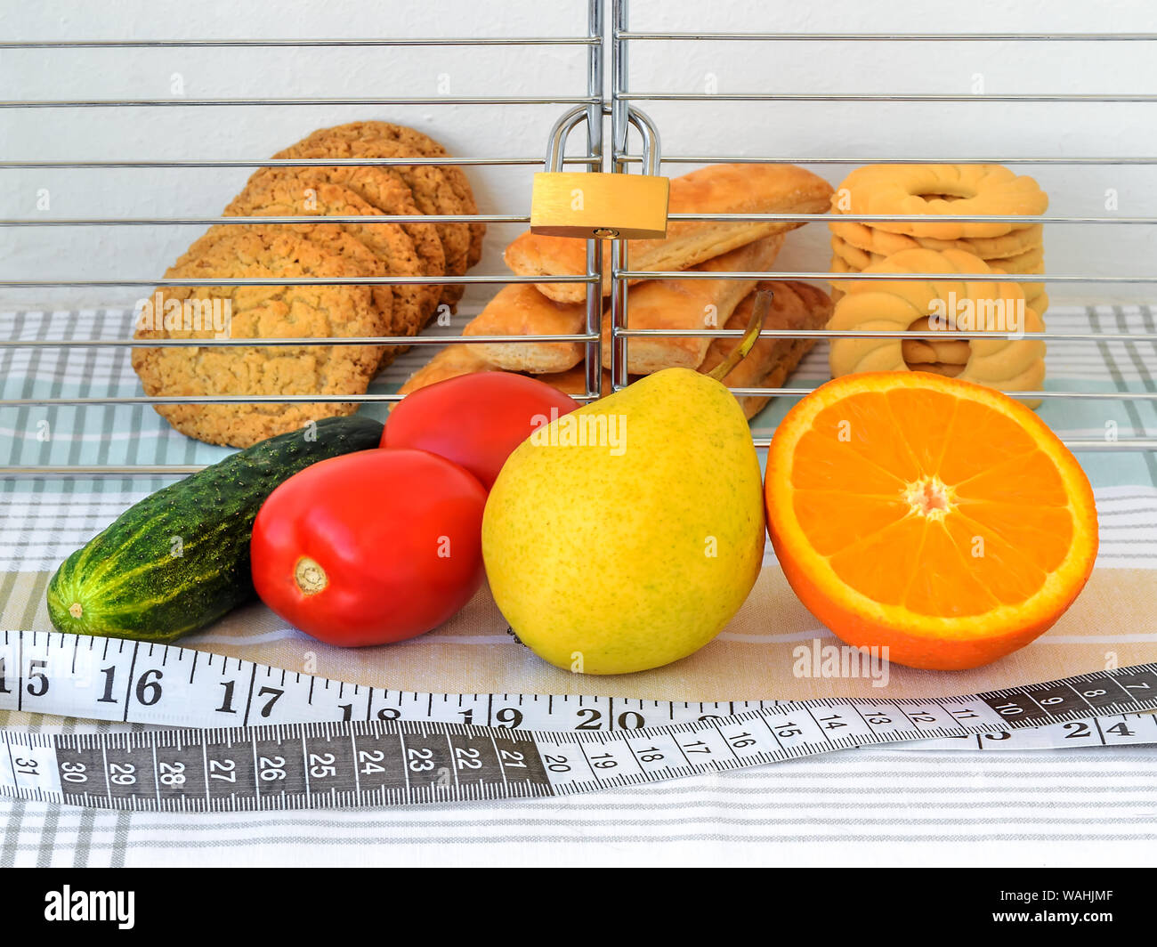Cookies are in the cage locked with padlock. Vegetables, fruits and ...