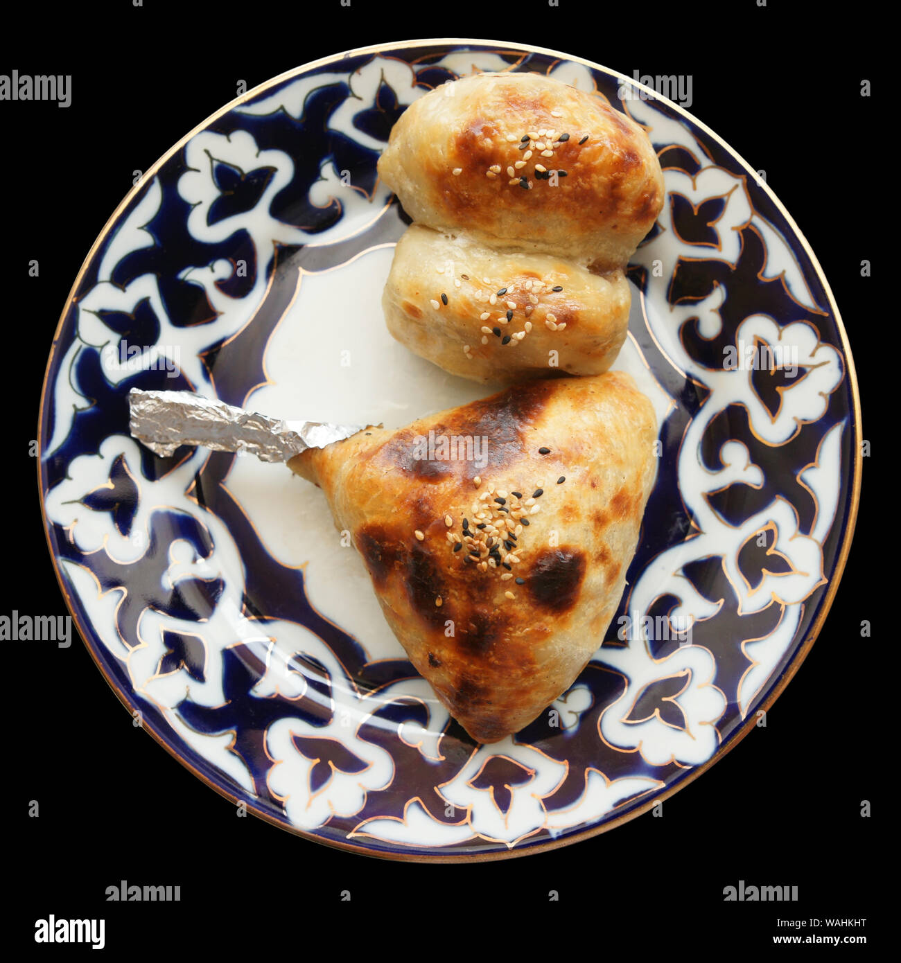 Smosa buns in plate isolated on black background Stock Photo - Alamy