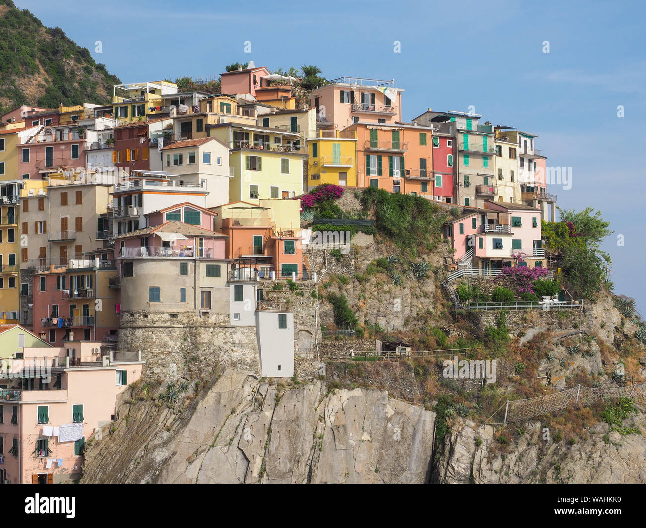 View of Manarola. Colorful historic buildings on a steep cliff close up ...
