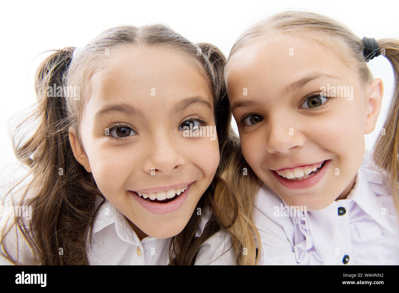 A whole new look. Happy school girls. Adorable little girls smiling ...