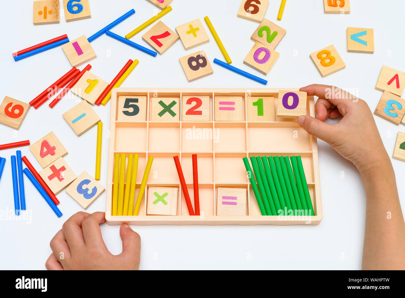 kid doing multiplication equation using counting rods Stock Photo - Alamy