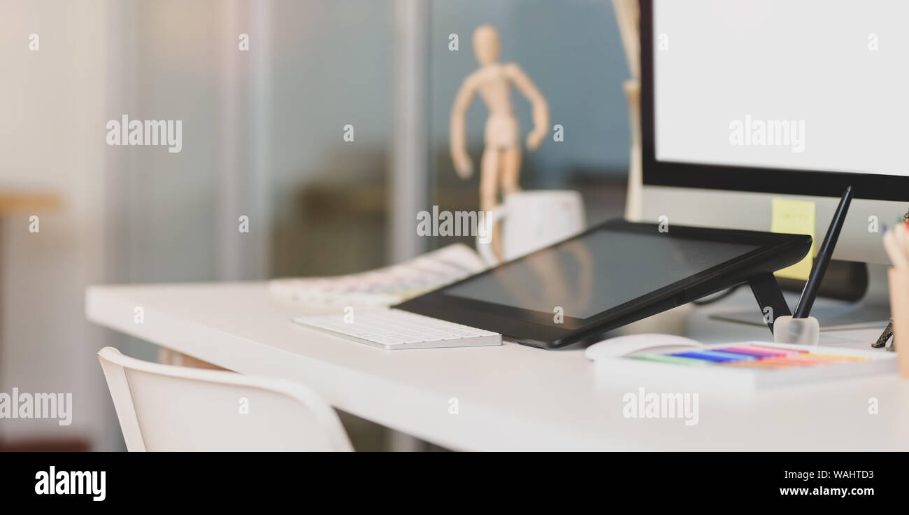 Modern designer workplace with graphic tablet and office supplies with ...