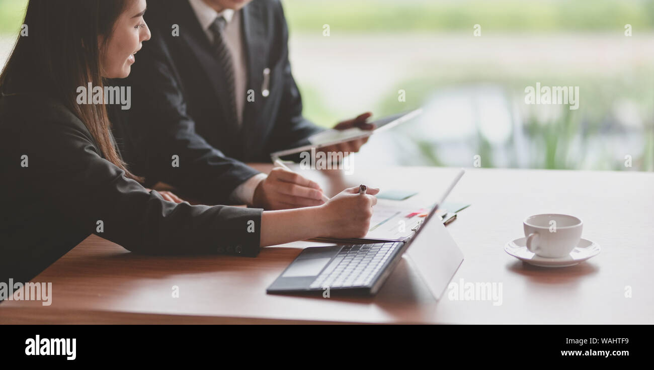 Two motivated businesspeople exchanging the idea for project together ...