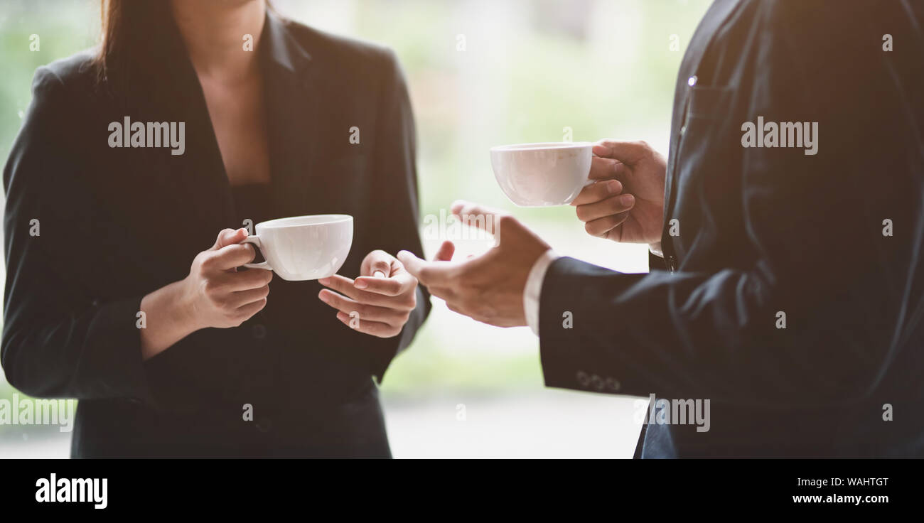 Professional business team discussing while having coffee break during ...