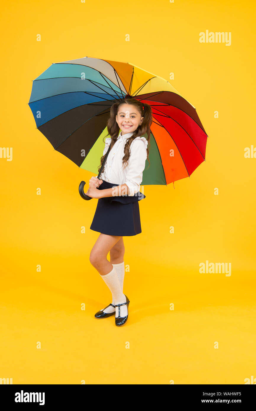 Fancy schoolgirl. Girl with umbrella. Rainy day. Happy childhood. Kid happy with umbrella. Fall ...
