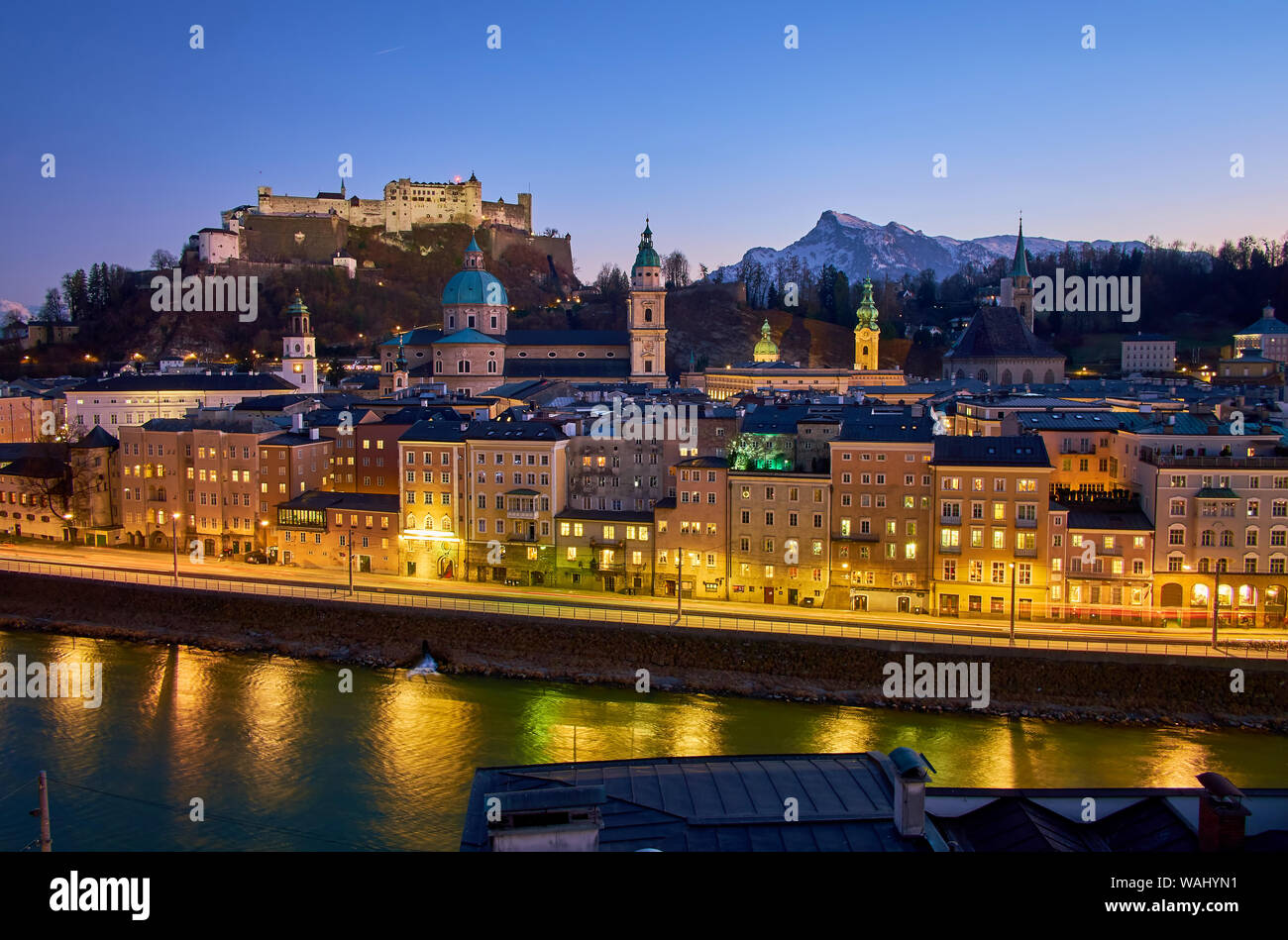 The dark evening sky over old Salzburg gives the illuminated streets ...