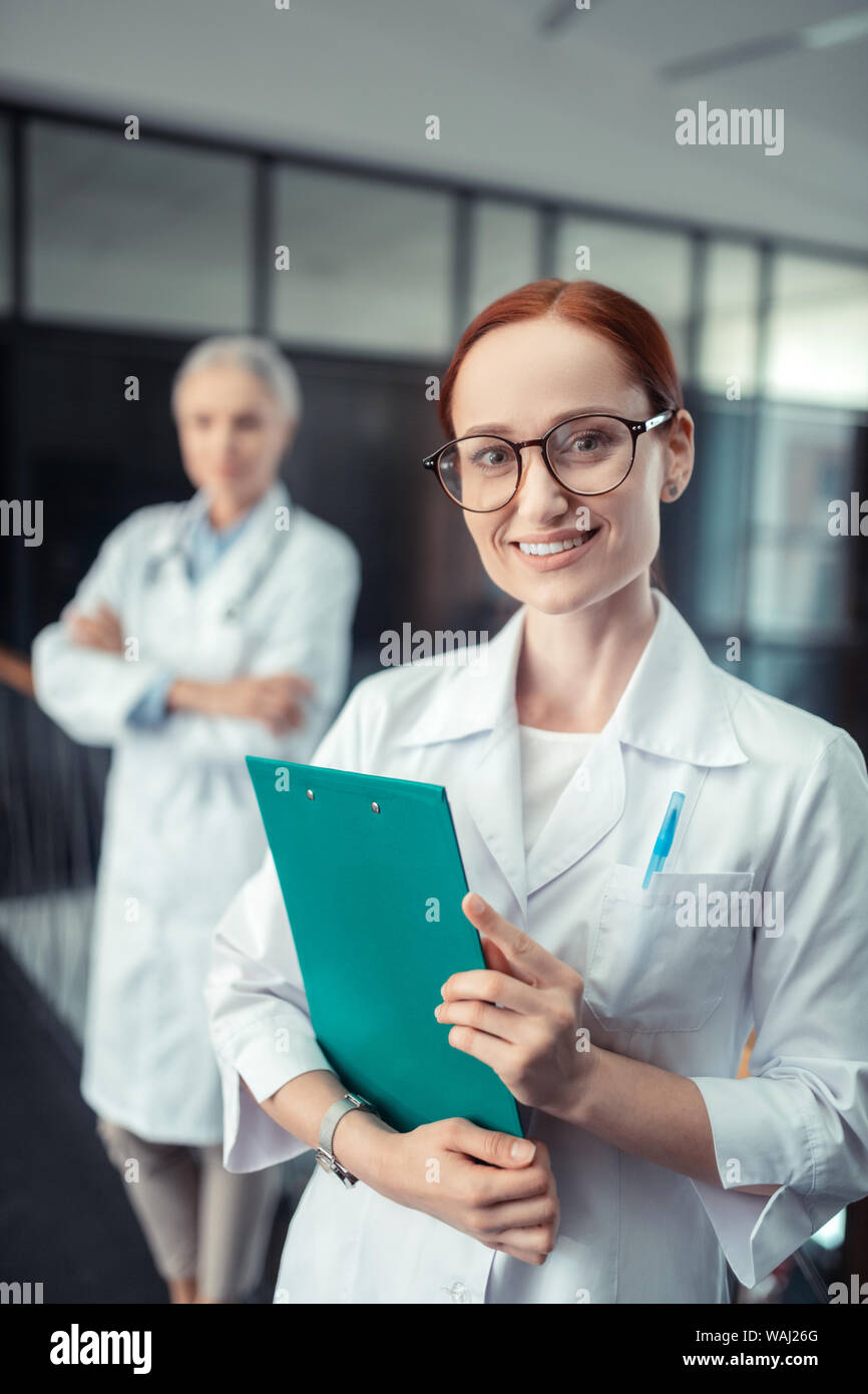 Smiling female doctor looking in front of her Stock Photo - Alamy