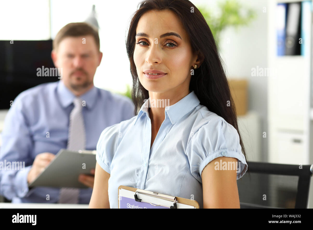 Beautiful clerk looking in camera during business meeting Stock Photo ...