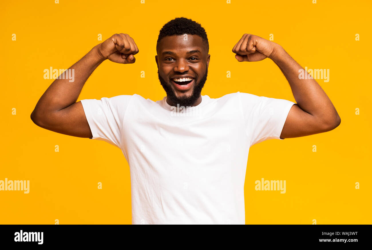 Portrait young man flexing biceps hi-res stock photography and images ...