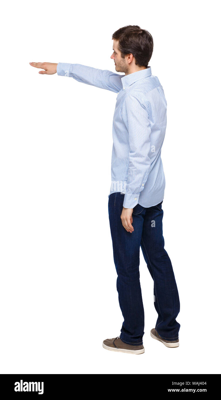 Back view of a man in jeans points his hand upwards. Rear view people ...