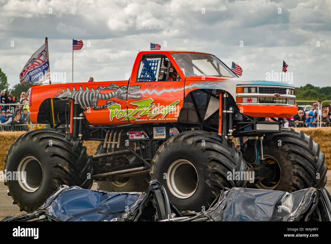 The Podzilla monster truck crushing and destroying a stack of scrap ...