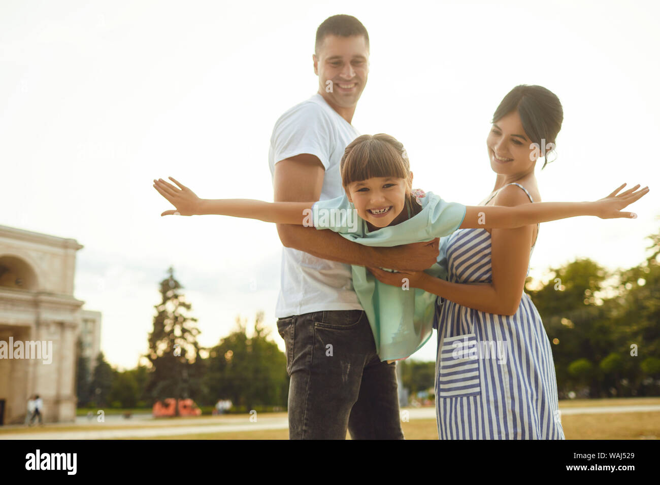 Happy smiling family walking on the street Stock Photo - Alamy