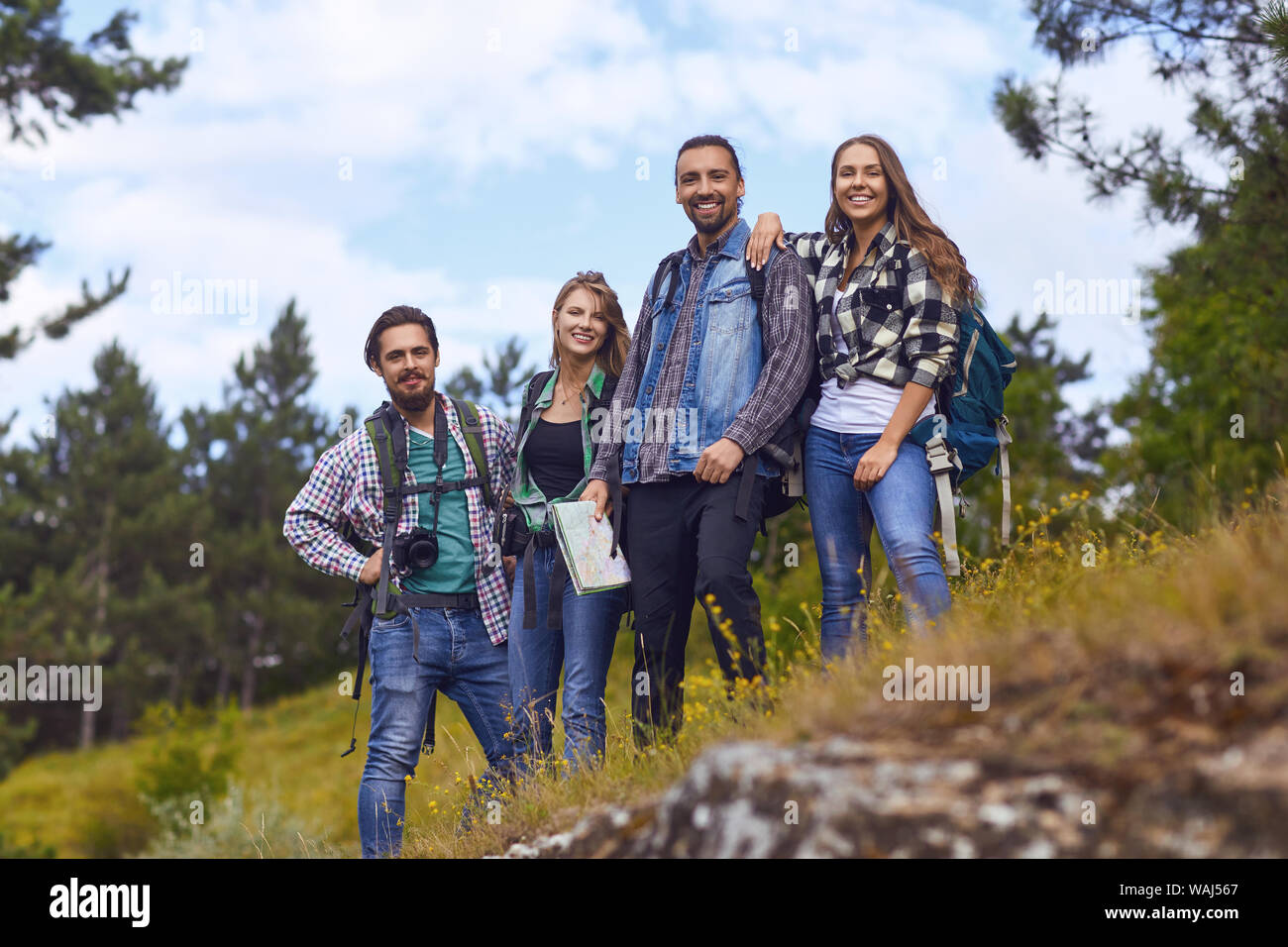 A group of tourists with backpacks are standing in the forest Stock ...