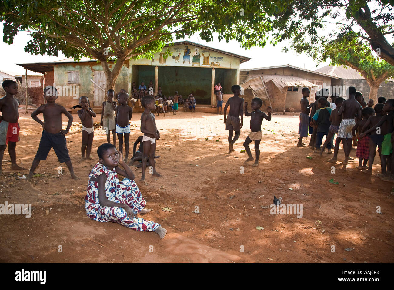 West Africa, Benin. Children gathered in village before Gelede Mask ...