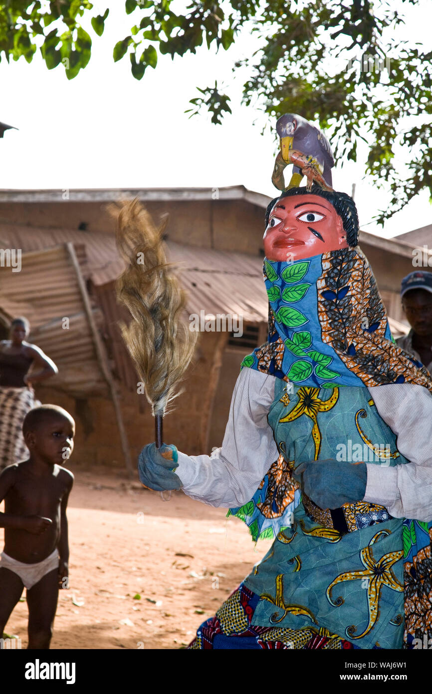 West Africa, Benin. Young child watches Gelede Mask Dancers perform ...