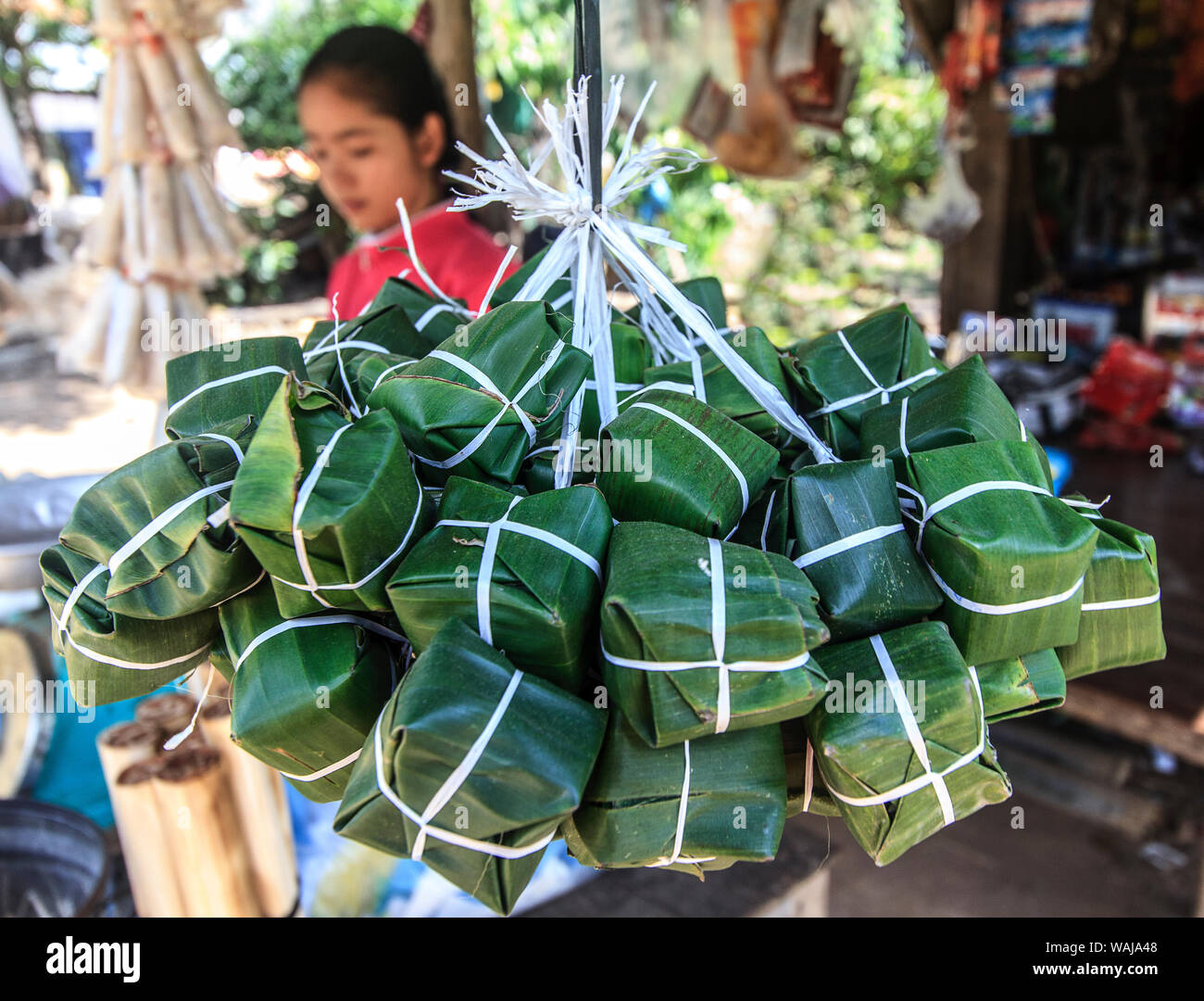 Kratie, Cambodia. Packets of sticky rice with banana and coconut ...
