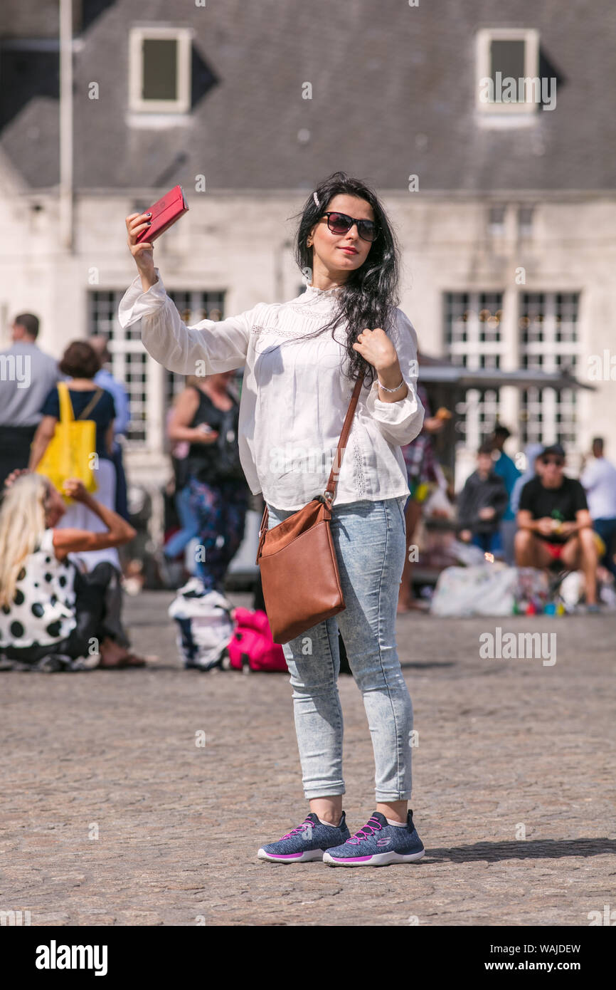 Tourist makes selfie on Dam Square. Selfies are incredible popular ...