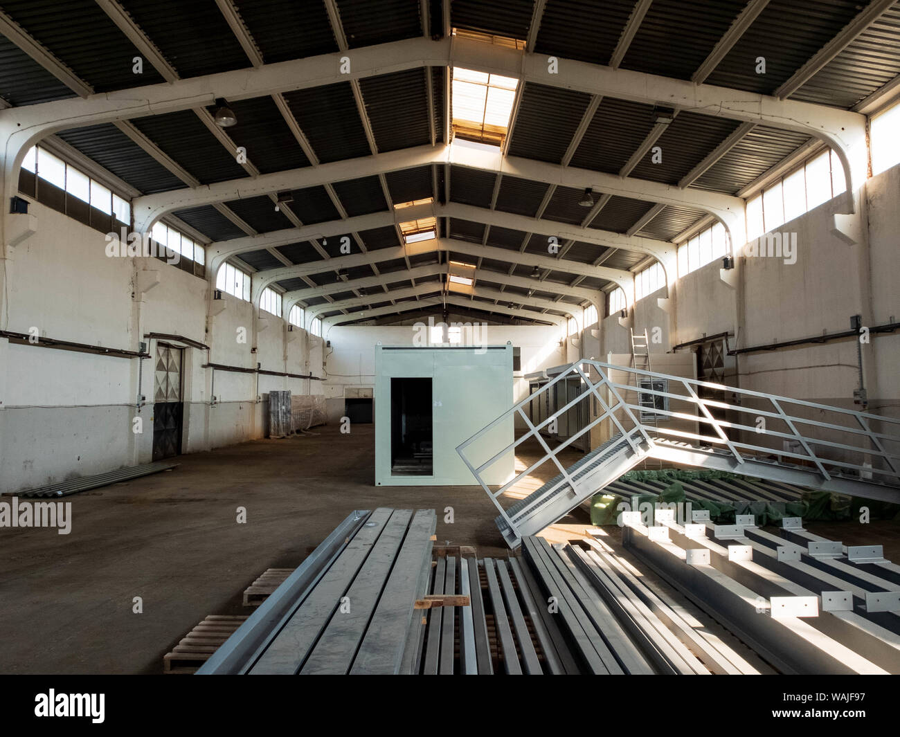 Interior of the old warehouse with piled construction materials Stock ...