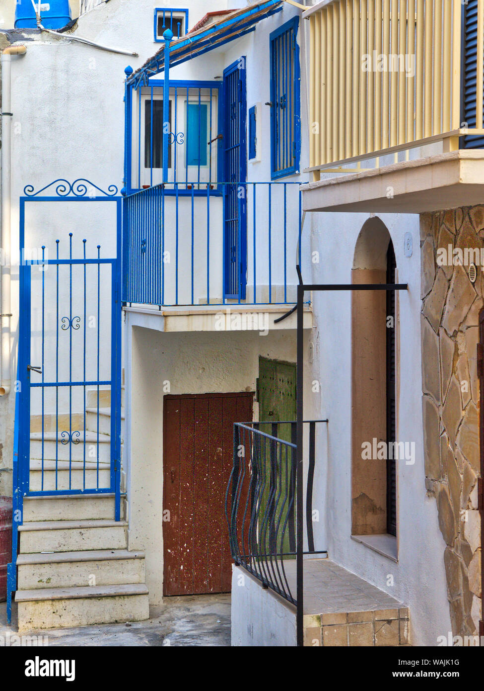 Italy, Apulia, Foggia, Vieste. Homes with blue gates, railing and door ...
