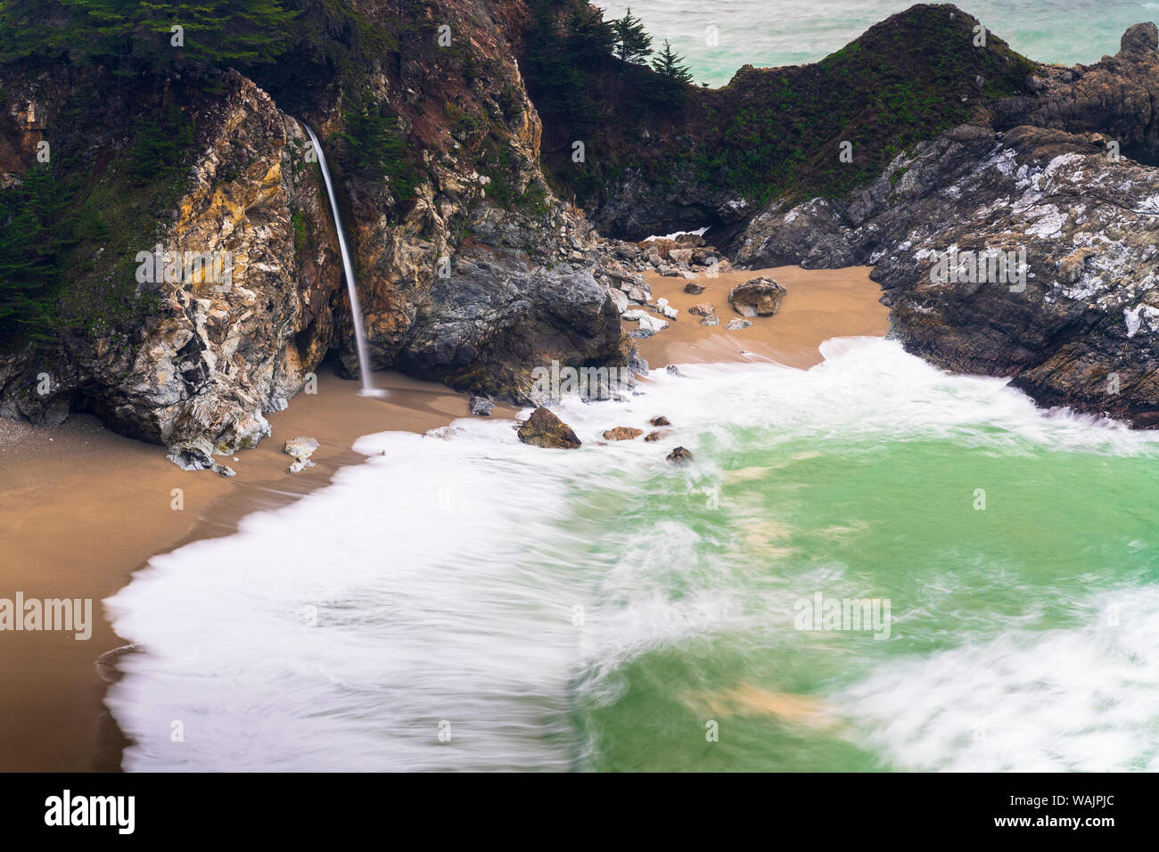 Slow moving waves into the cove of McWay Falls in Big Sur Stock Photo ...