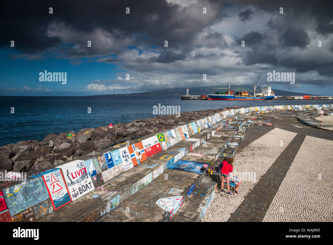 Portugal, Azores, Faial Island, Horta. Yacht marina, women cutting ...