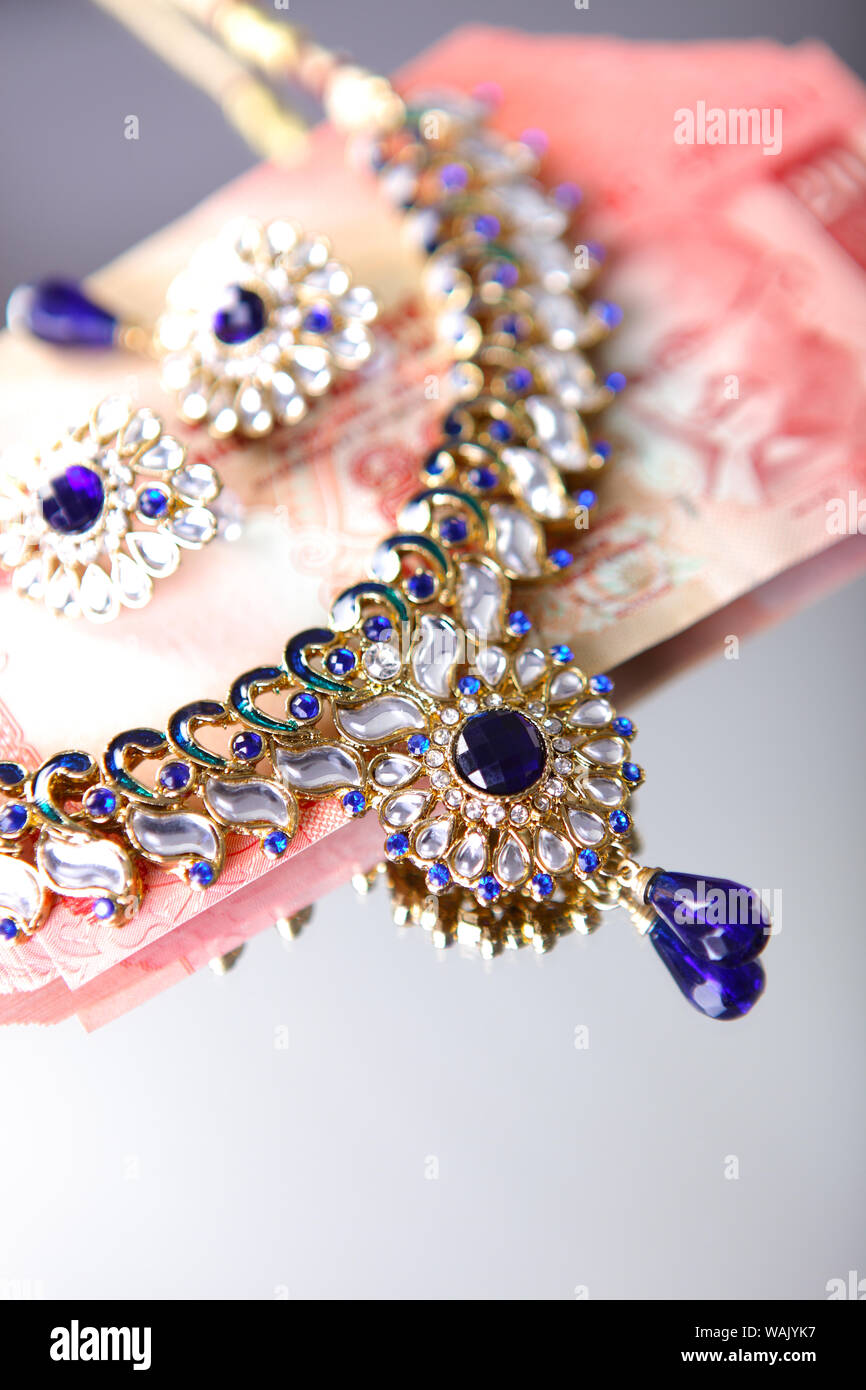 Necklace with banknotes representing Gold Loan concept Stock Photo - Alamy