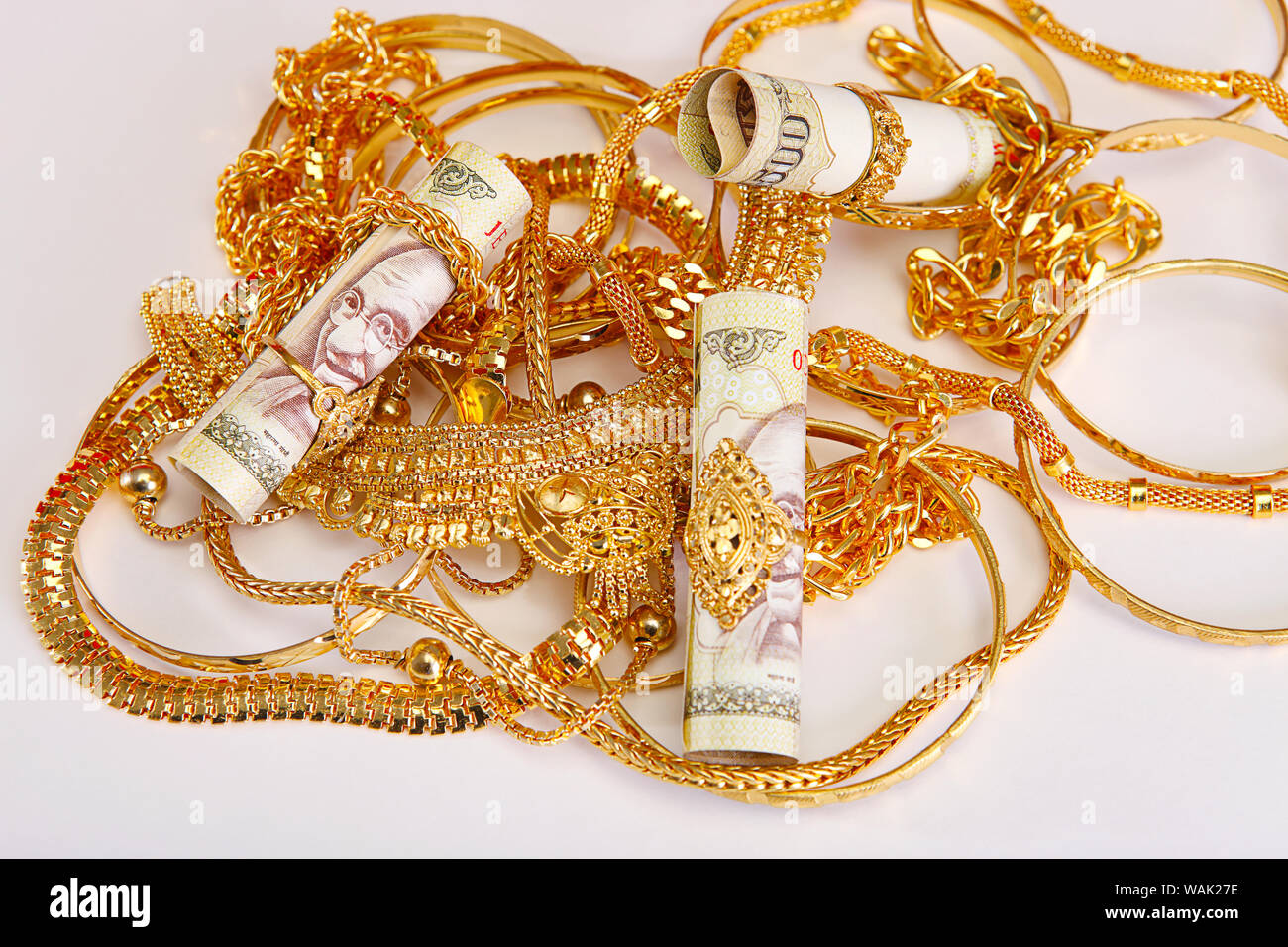 Jewelry with banknotes representing Gold Loan concept Stock Photo - Alamy