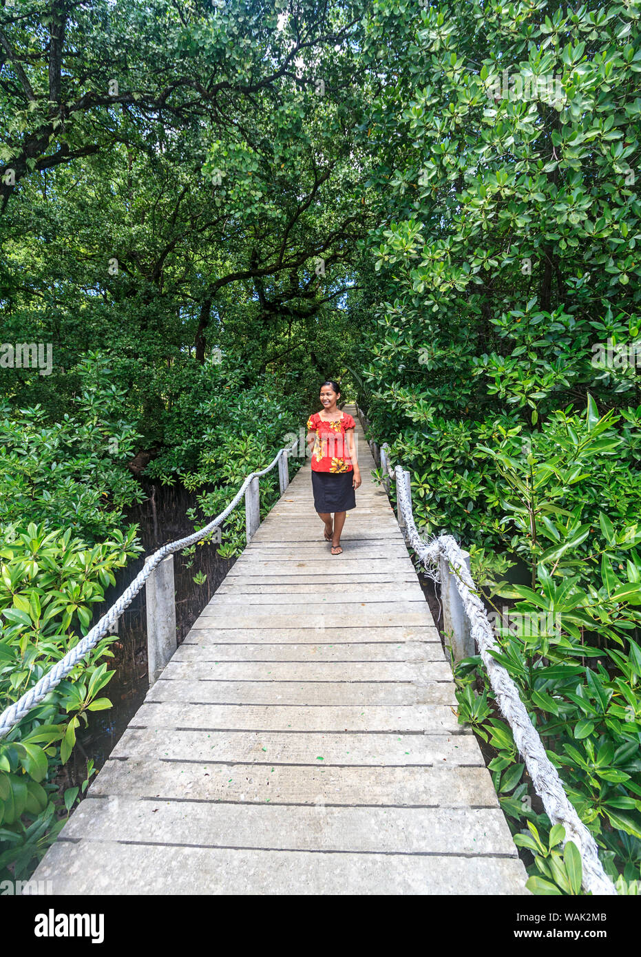 Kosrae, Micronesia (FSM). Young woman walking along boardwalk through ...