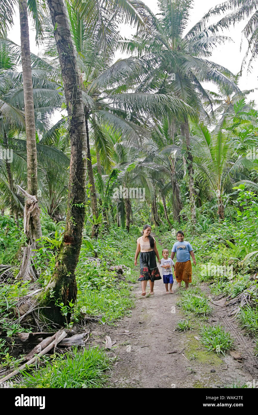 Kosrae, Micronesia (FSM). Young girl and her two brothers walking the ...