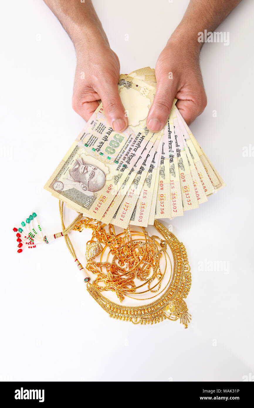 Jewelry with banknotes representing "Gold Loan" concept Stock Photo - Alamy