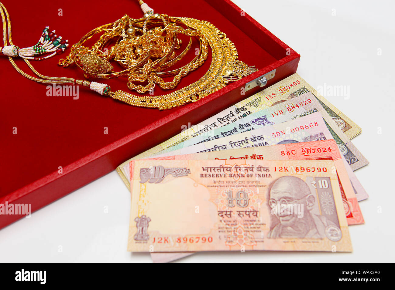 Jewelry with banknotes representing Gold Loan concept Stock Photo - Alamy