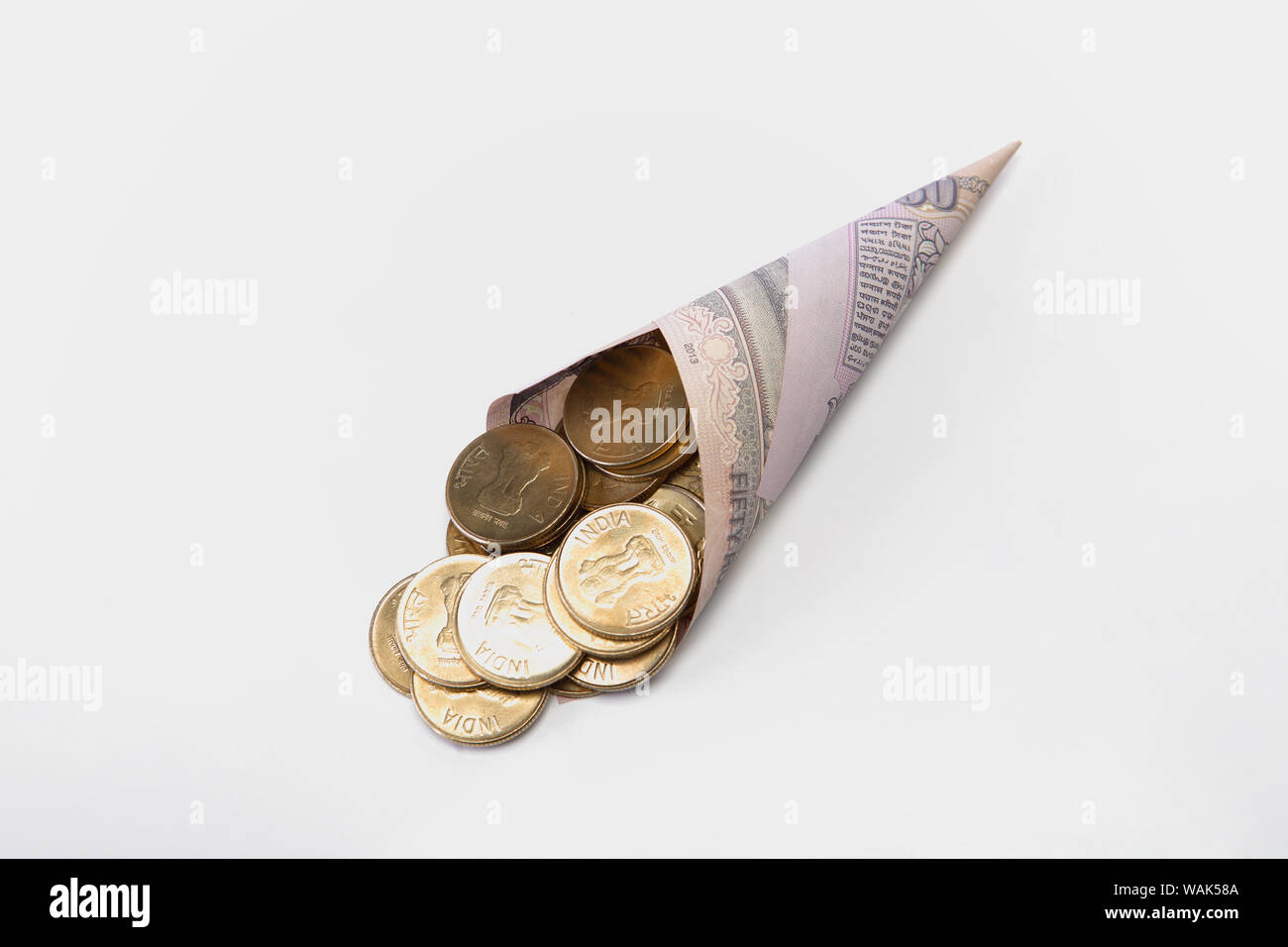 Paper cone of fifty rupee note full of coins Stock Photo - Alamy