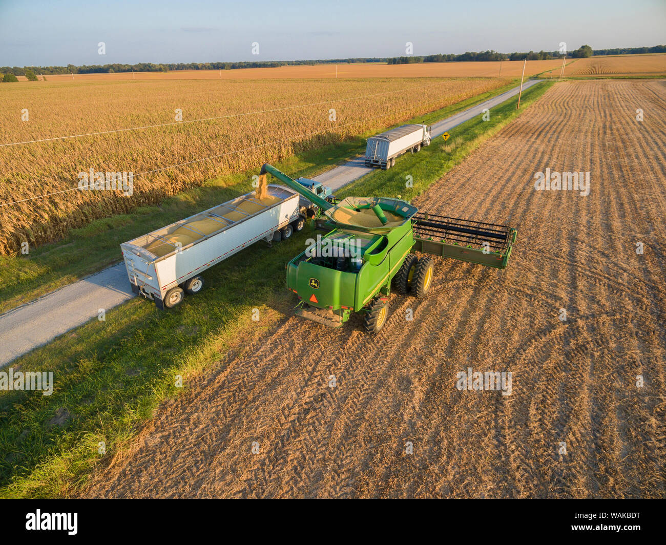 John Deere combine unloading soybeans into truck. Marion County ...