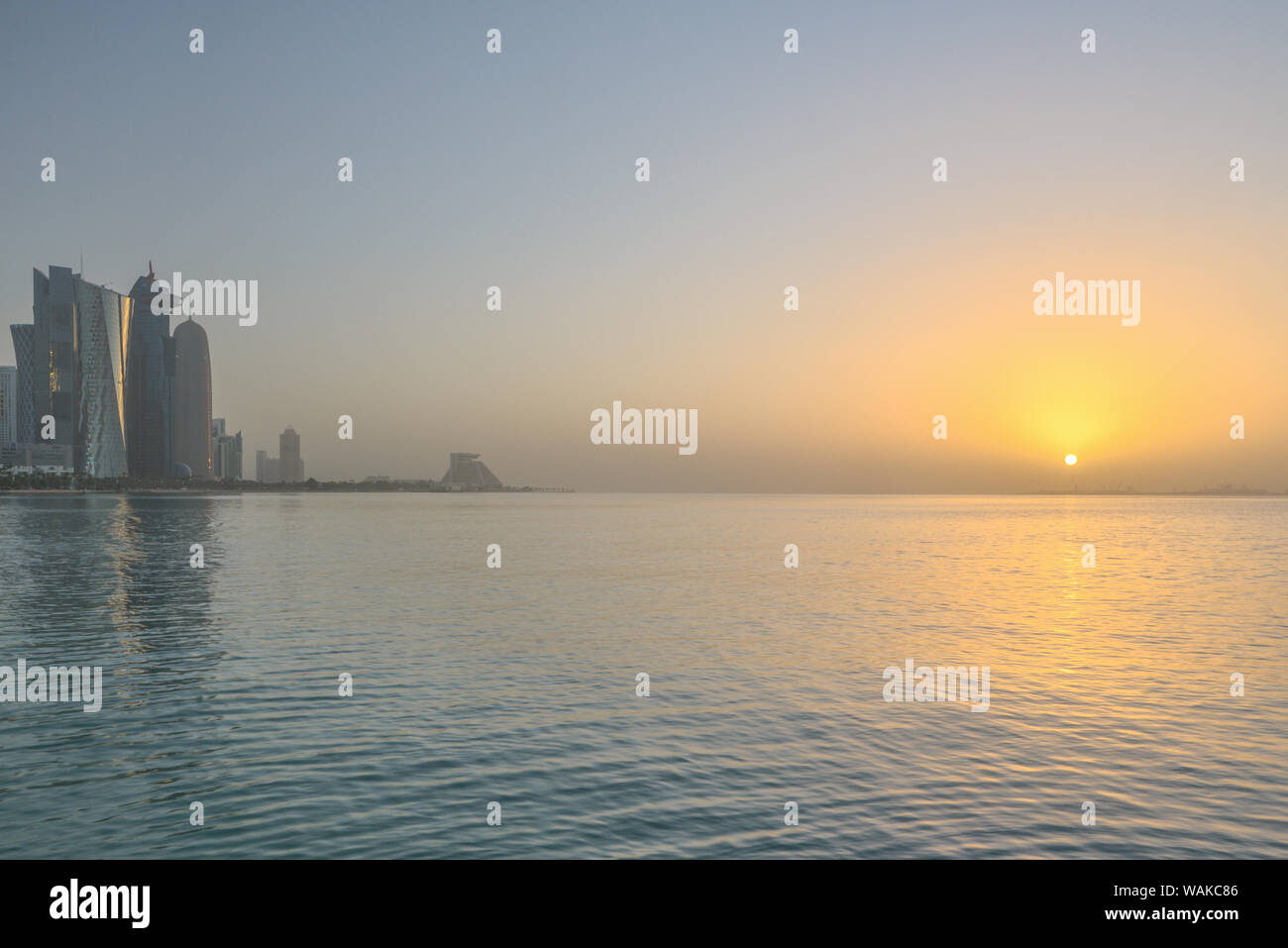 Panoramic view of Wets Bay's skyscrapers at dawn with sun rising above ...
