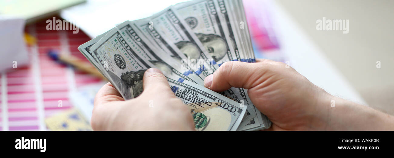 Male hands counting money from huge pack Stock Photo - Alamy