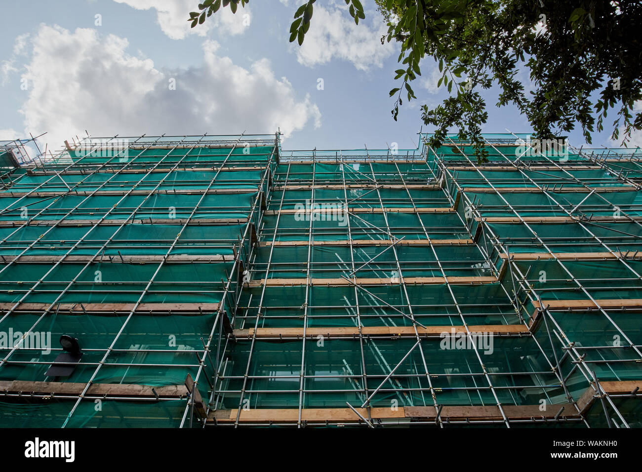 Professional scaffolding on the side of a building under renovation ...
