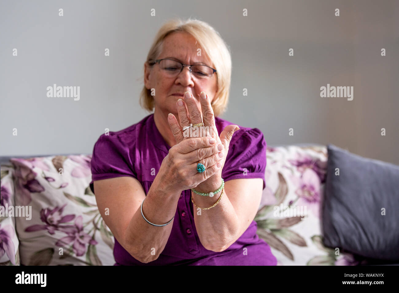 Elderly woman suffering from pain in hand, arthritis old person and ...