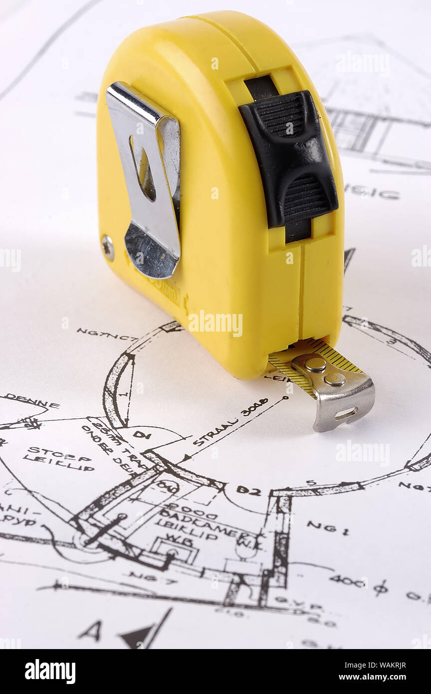 A yellow measuring tape on a architectural plan Stock Photo - Alamy