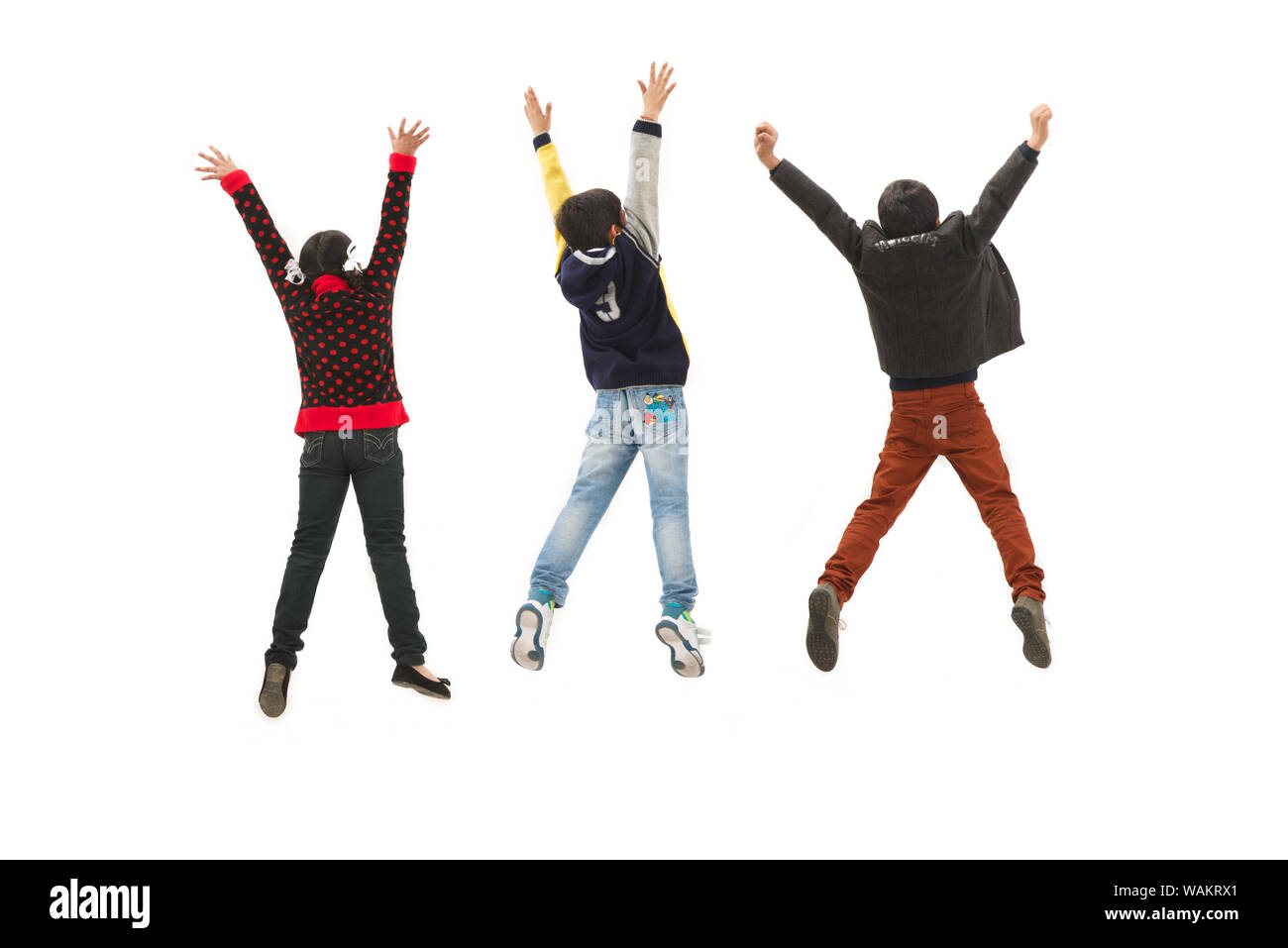 Three children jumping Stock Photo - Alamy