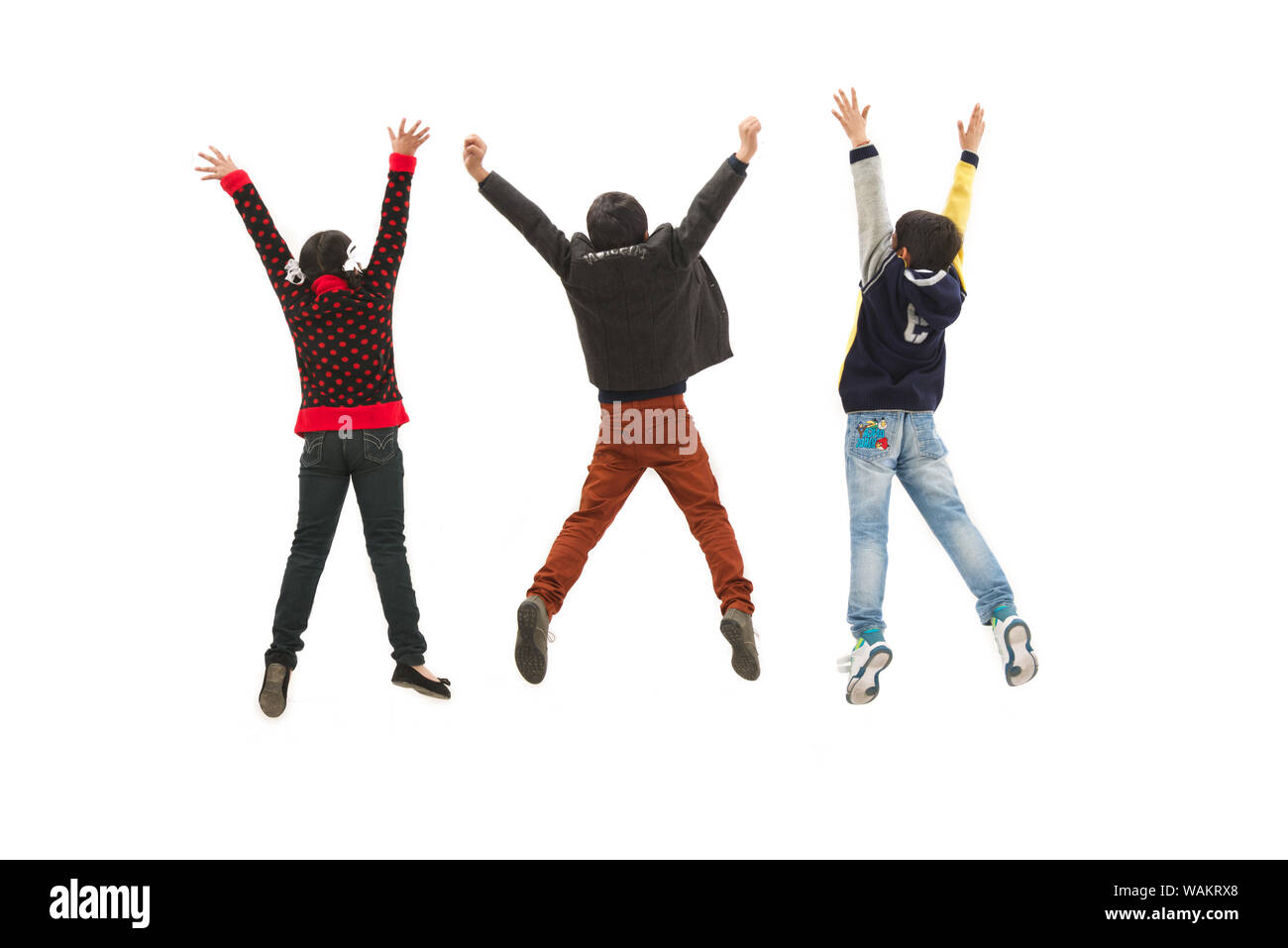 Three children jumping Stock Photo - Alamy