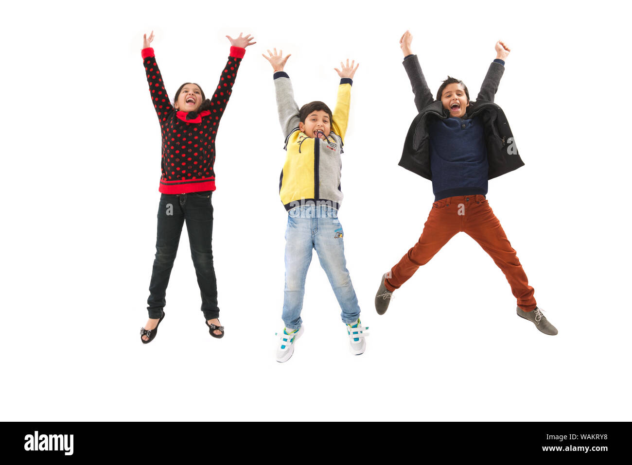 Three children jumping Stock Photo - Alamy